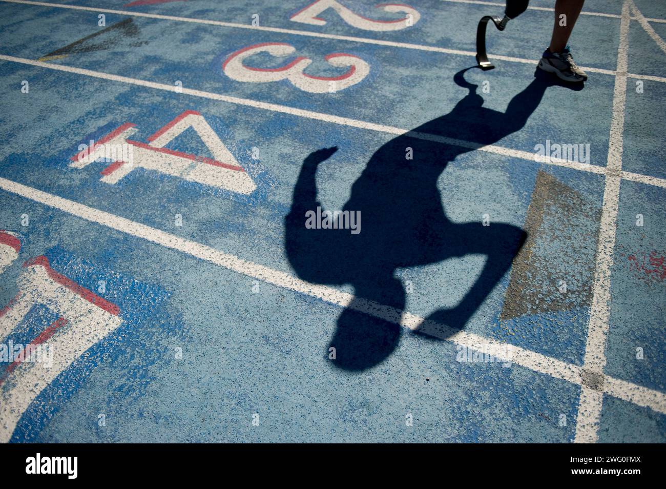An athlete with his running prosthetic prepares for track practice ...