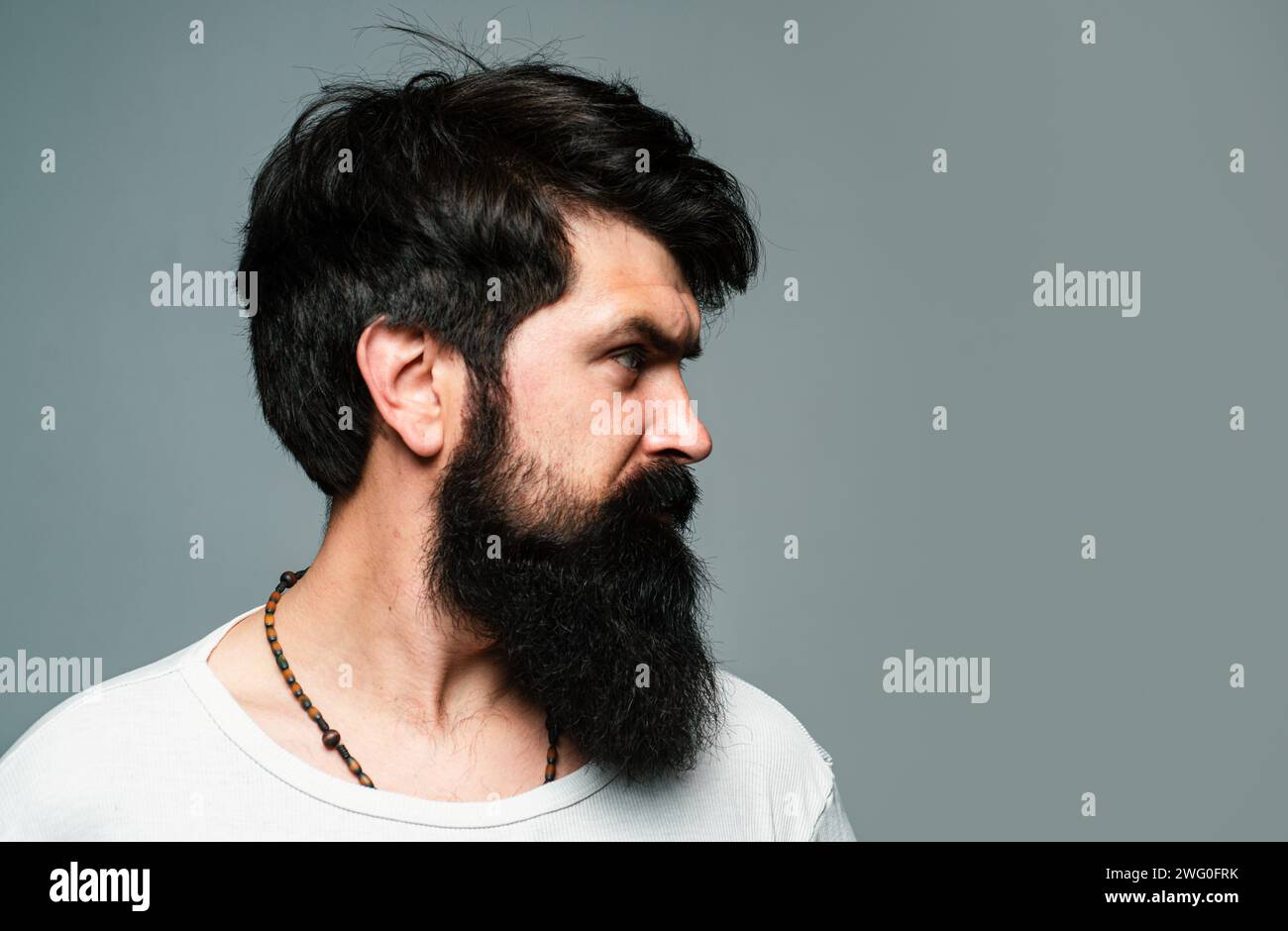 Half-turned side profile portrait of serious man has beard and mustache ...