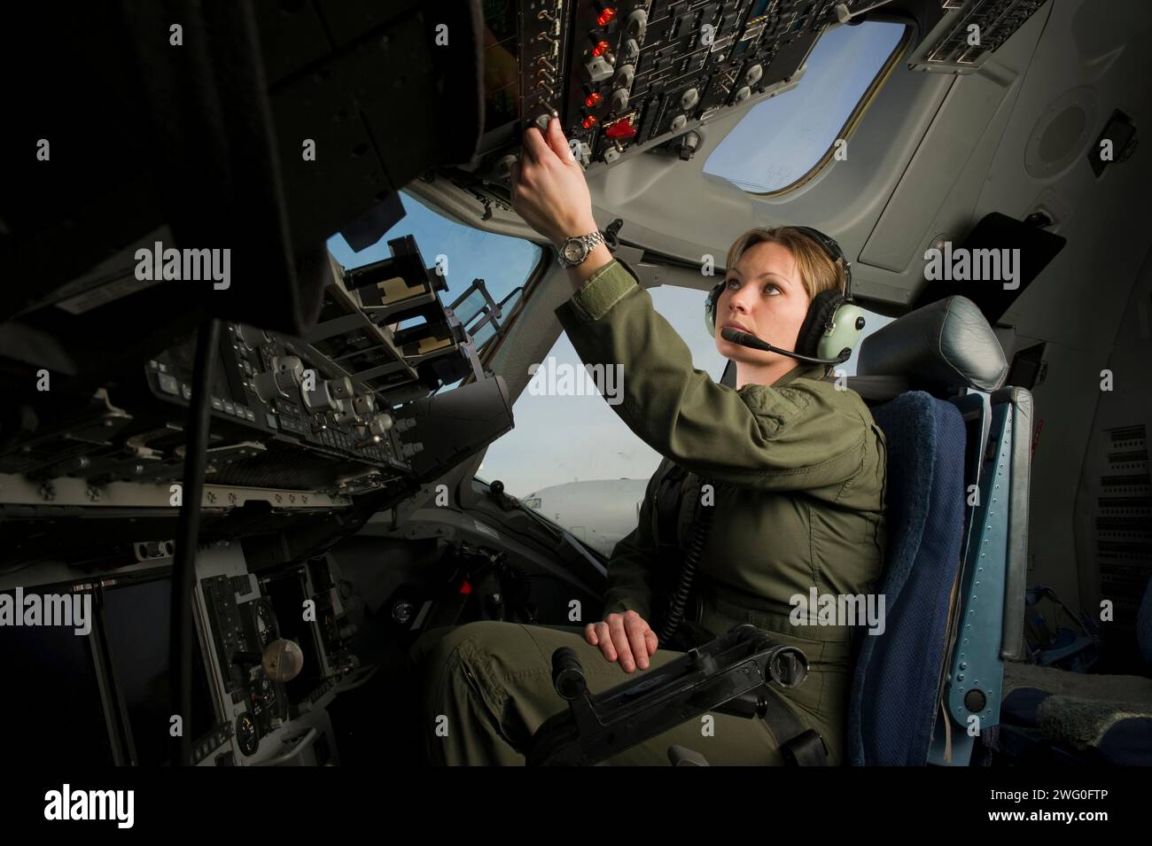 A U.S. Air Force pilot conducts her preflight checklist during engine ...