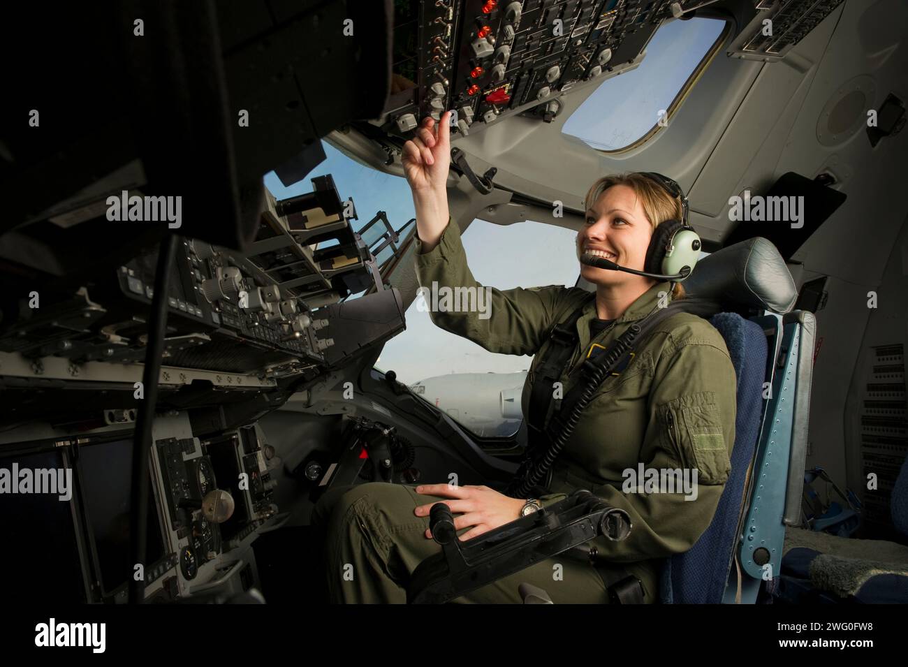 A U.S. Air Force pilot conducts her preflight checklist during engine ...