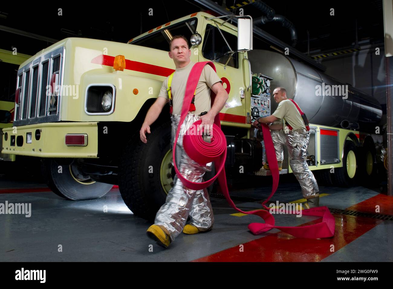 U.S. Air Force firemen attach a hose to the fire engine Stock Photo - Alamy