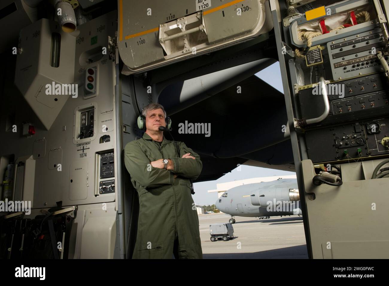 A U.S. Air Force loadmaster stands in the troop door that overlooks the ...