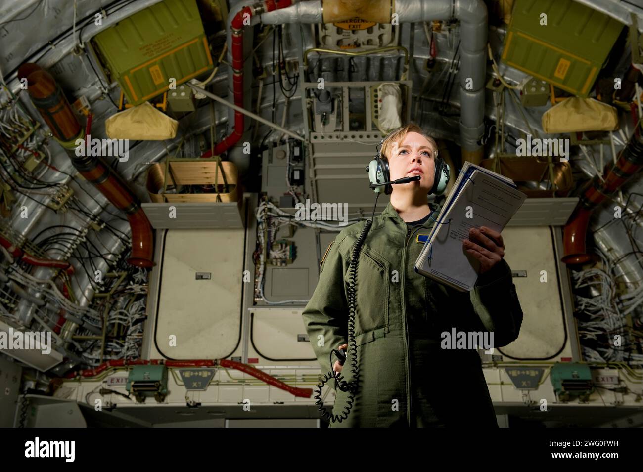 A U.S. Air Force loadmaster runs down her checklist in the cargo area ...