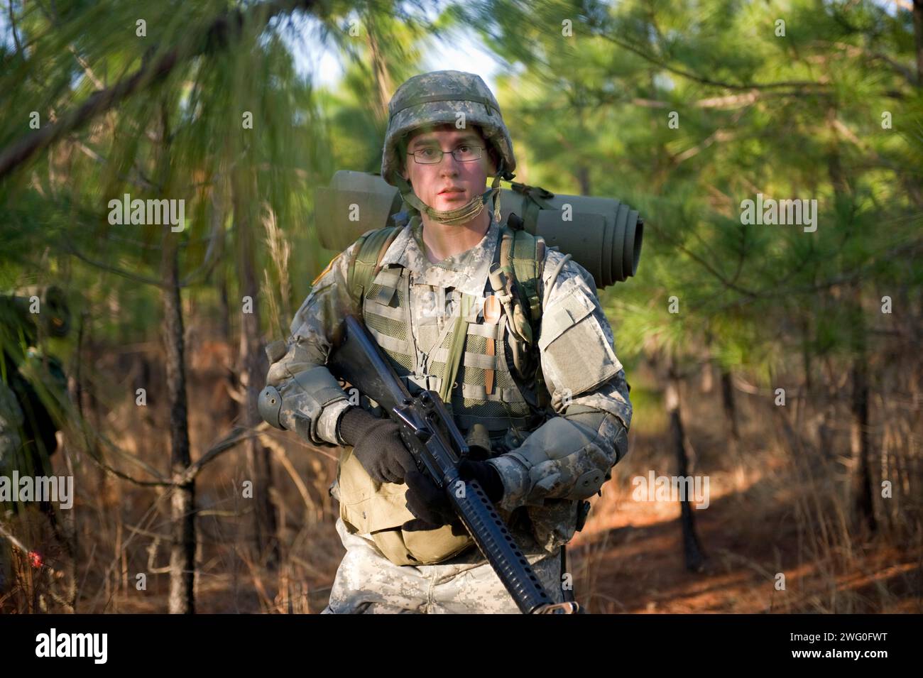 A soldier patrols through the woods during a field training exercise ...