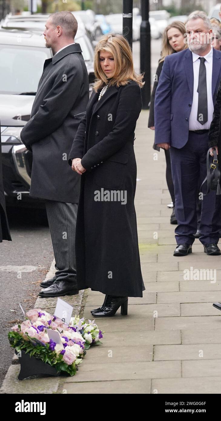 Kate Garraway looks at floral tributes as she waits for the arrival of ...