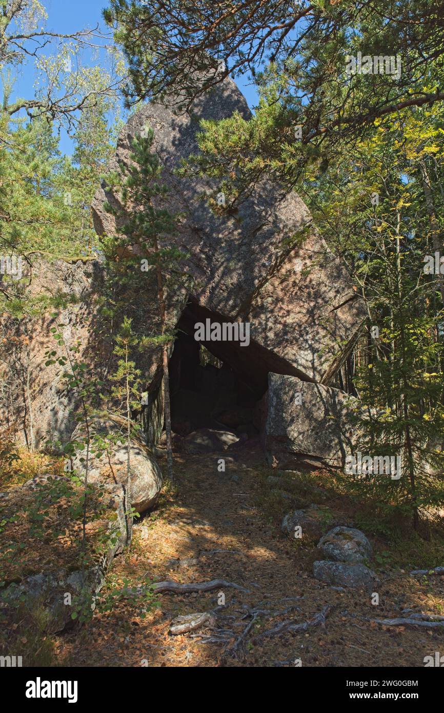 Rock formation of Korsvikin kivikirkko forming a cave in forest in ...