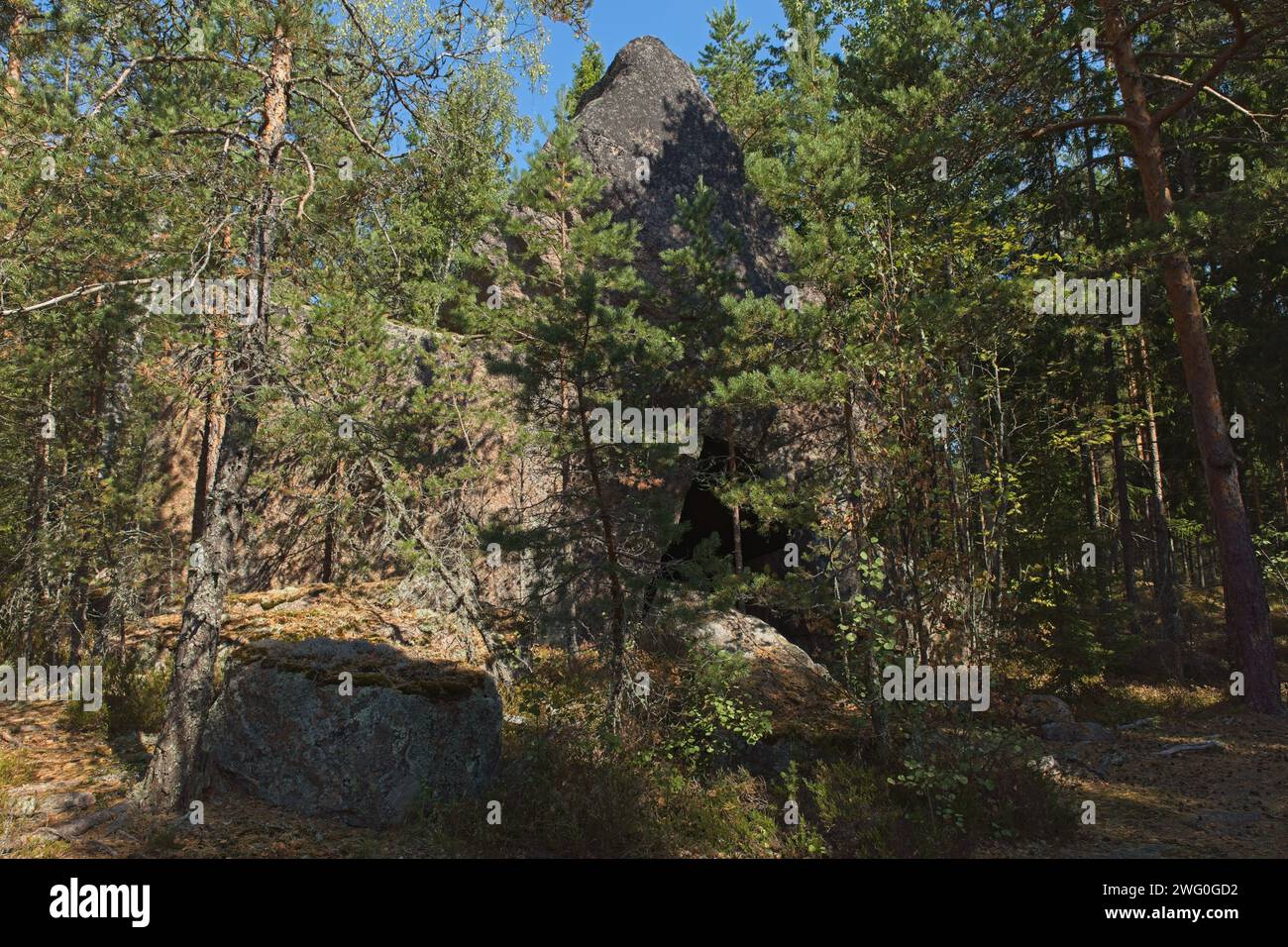Rock formation of Korsvikin kivikirkko forming a cave in forest in ...