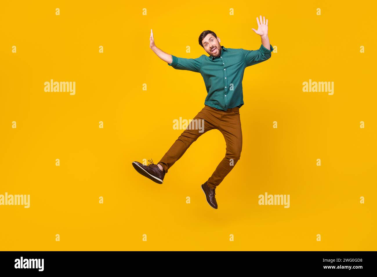 Full length photo of childish playful man dressed dotted shirt flying ...