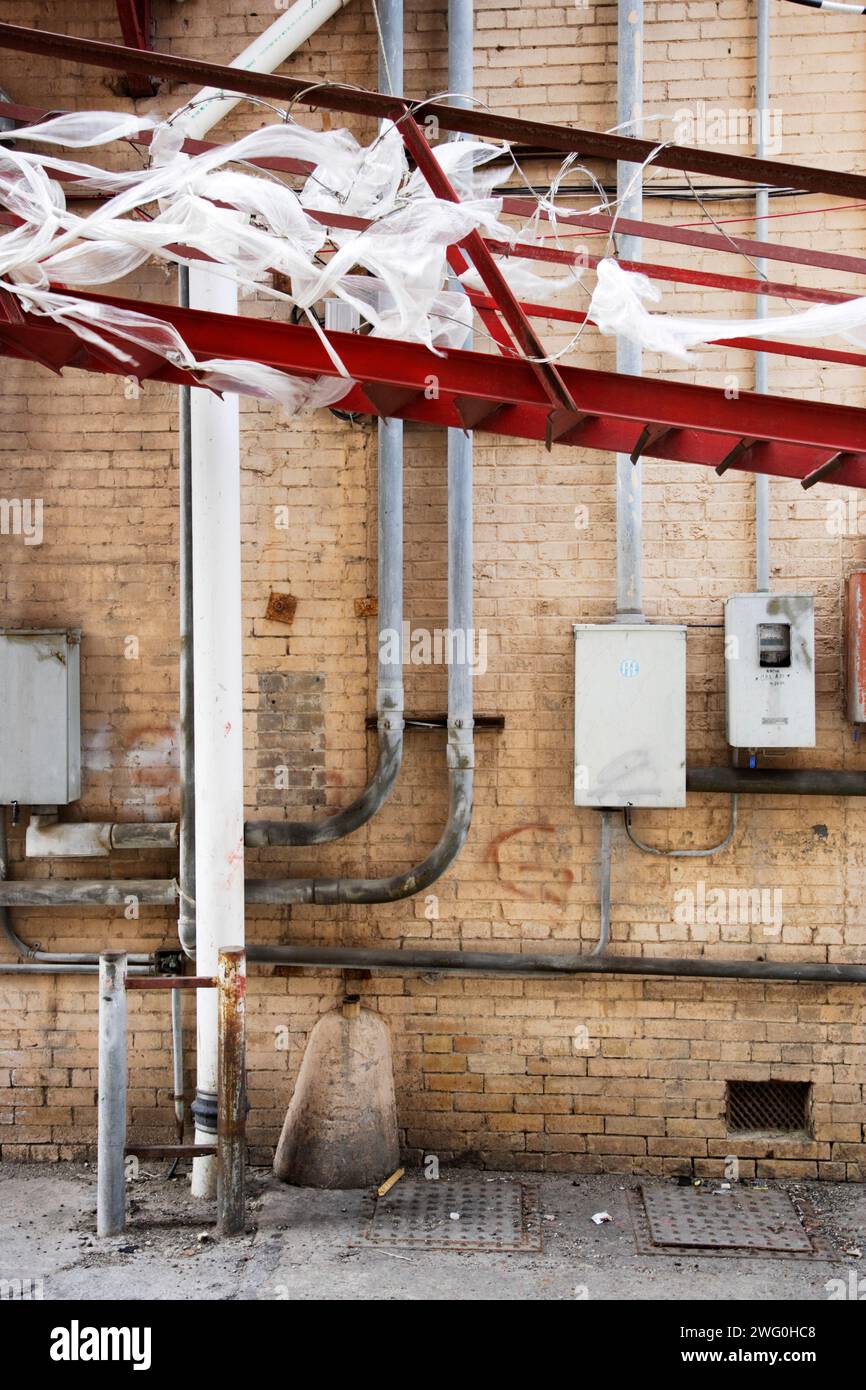 A windblown backstreet alley view, with red fire escape stairs Stock ...
