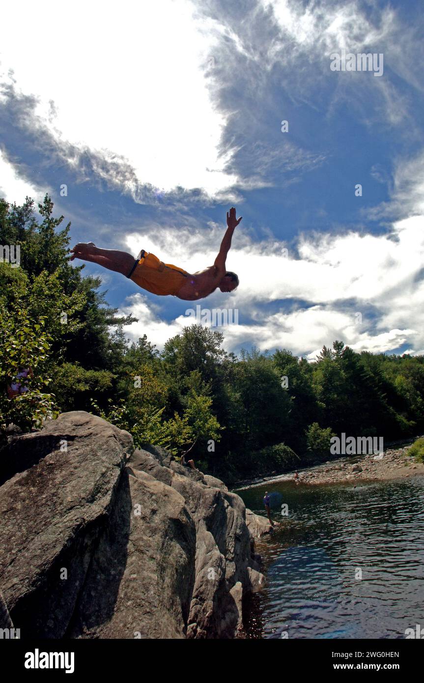 A swimmer makes a swan-dive into a river in Gaysville, Vermont Stock ...