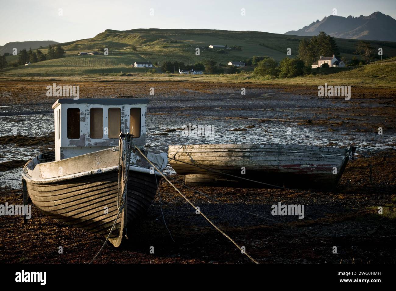 Two fishing boats rest on the ground during low tide, Isle of Skye ...