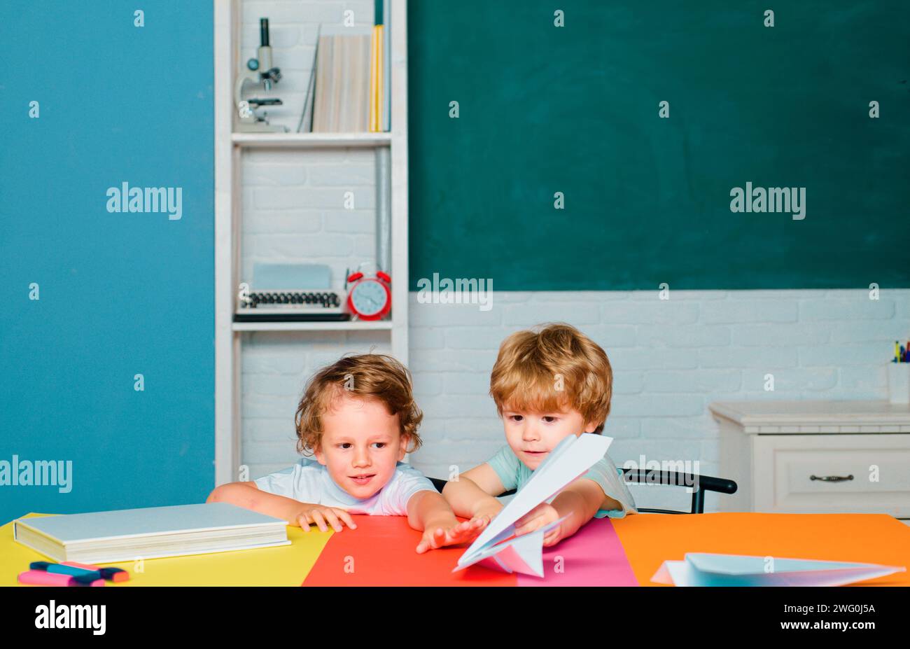 Cute little preschool kids boy pupils in classroom. School little kids ...