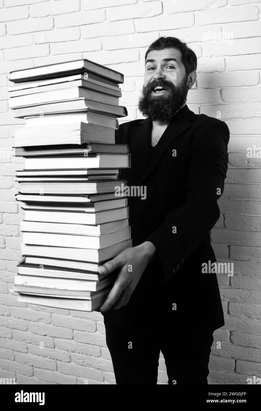 Funny teacher or professor with book stack. Thinking serious mature ...
