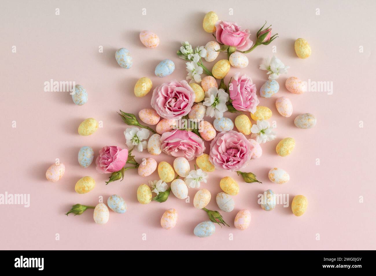 Pastel easter Eggs and Pink Roses Arrangement Stock Photo - Alamy