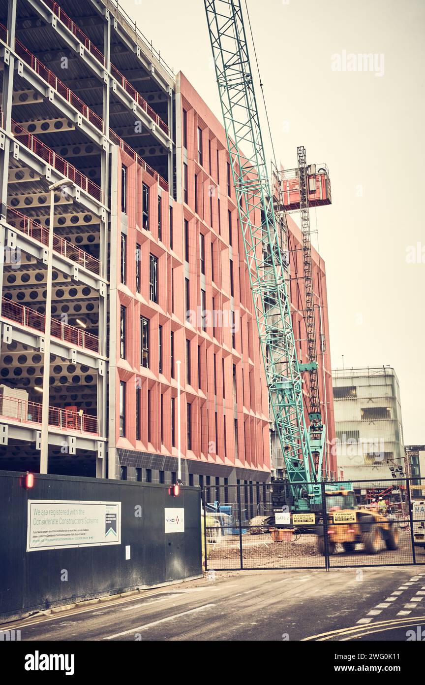 Hoists moving up and down side of building under construction Stock ...
