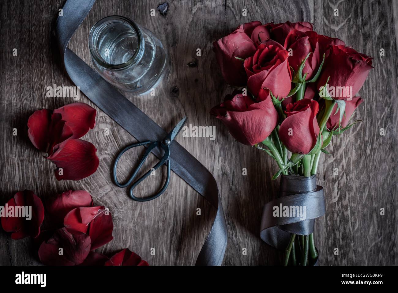 Overhead shot of blooming red roses wrapped in gray ribbon Stock Photo ...