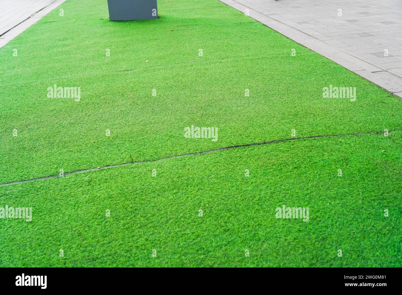 Artificial grass or lawn turf. Concrete walkway in the park Stock Photo ...