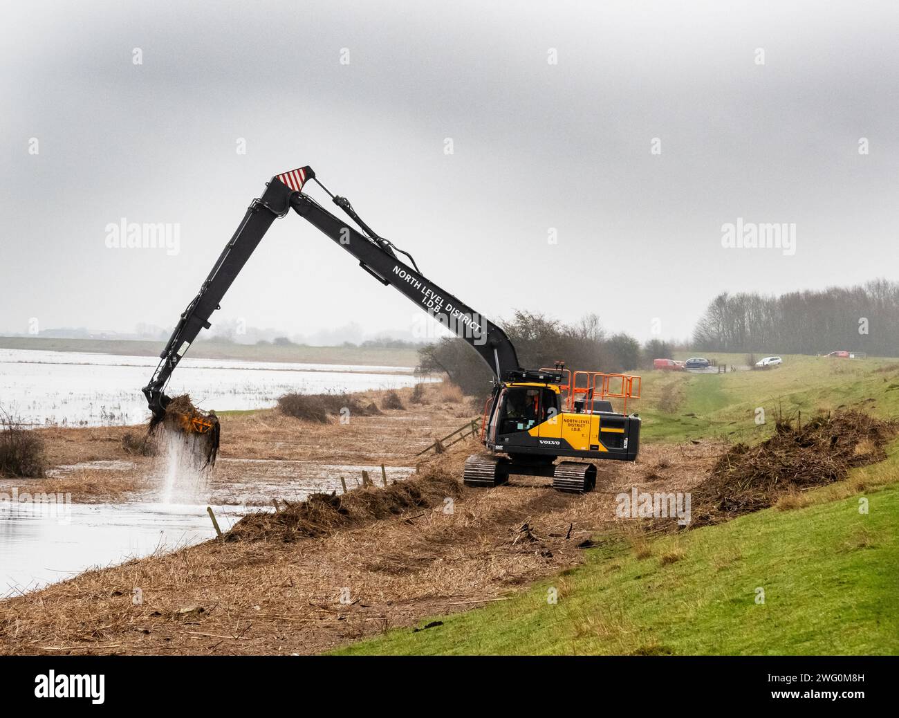 A machine clearing flood debris from a drainage ditch on the Nene ...