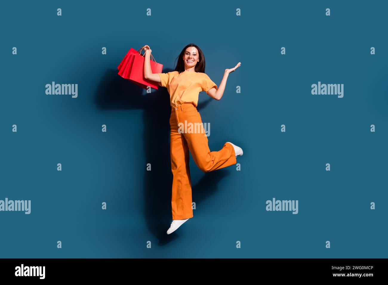 Full length photo of buyer woman jumping with red packages bargains ...