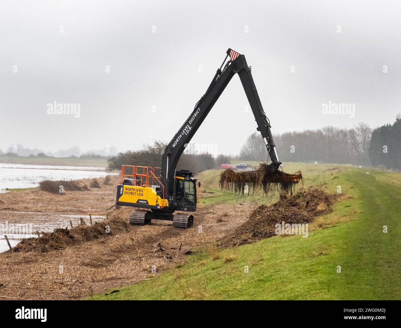 A machine clearing flood debris from a drainage ditch on the Nene ...