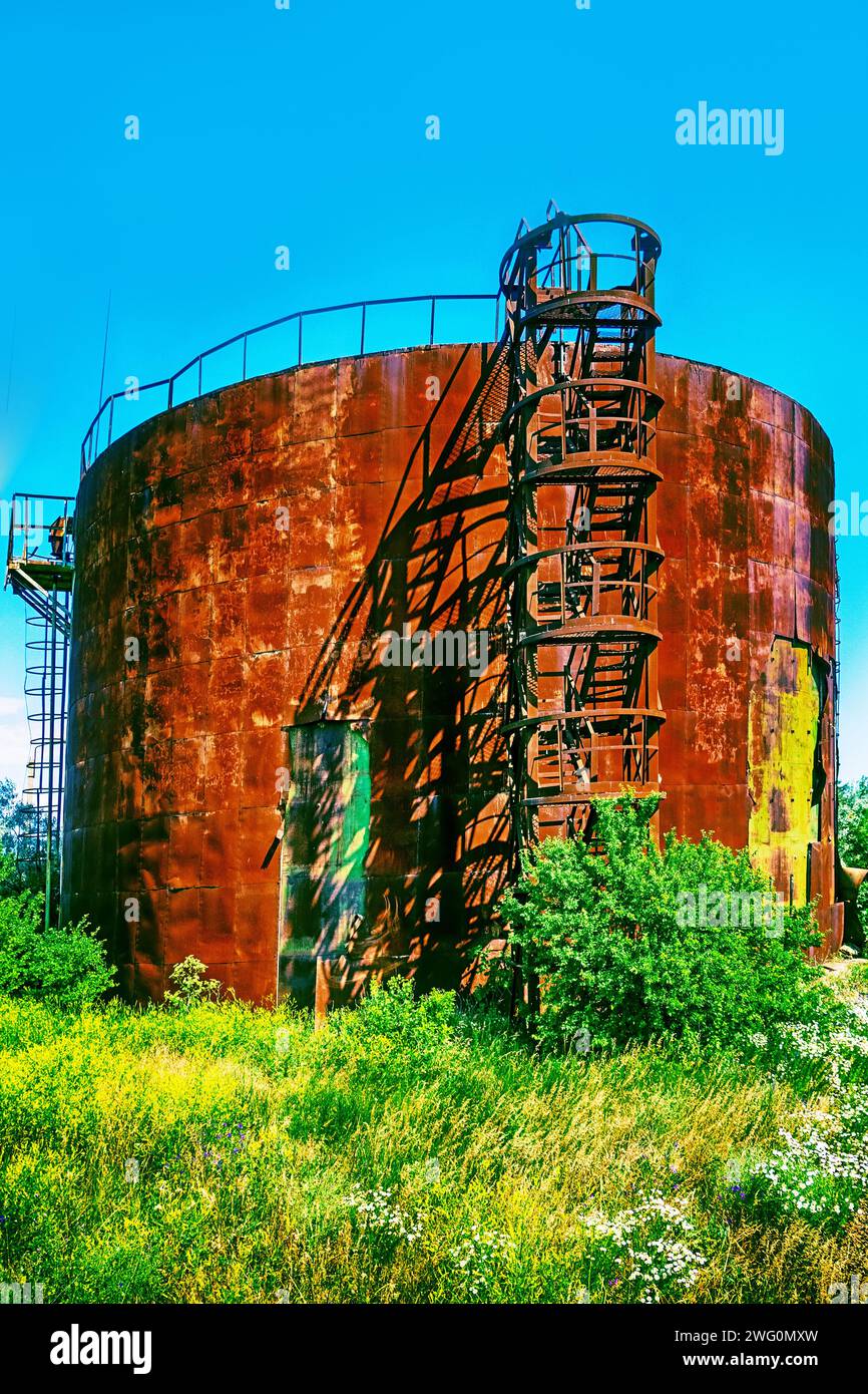 Old rusty oil tanks (fuel reservoir, oil barrel). Evidence of economic ...