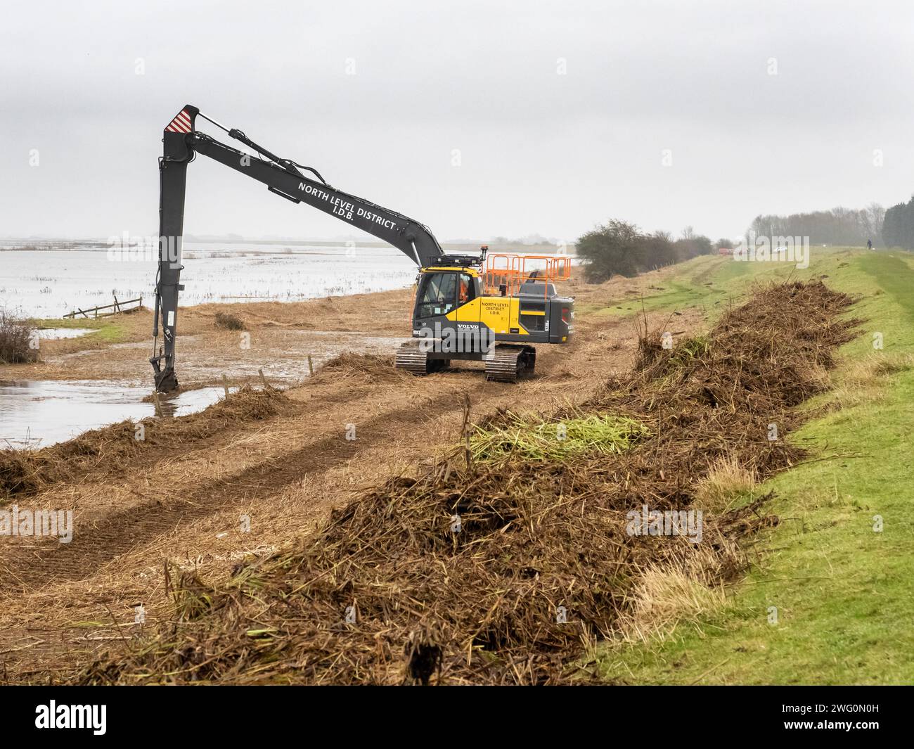 A machine clearing flood debris from a drainage ditch on the Nene ...