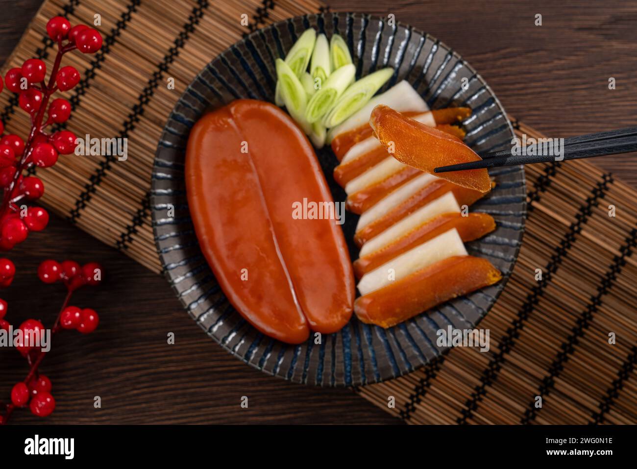 Delicious fresh mullet roe with white radish slices and garlic sprout ...