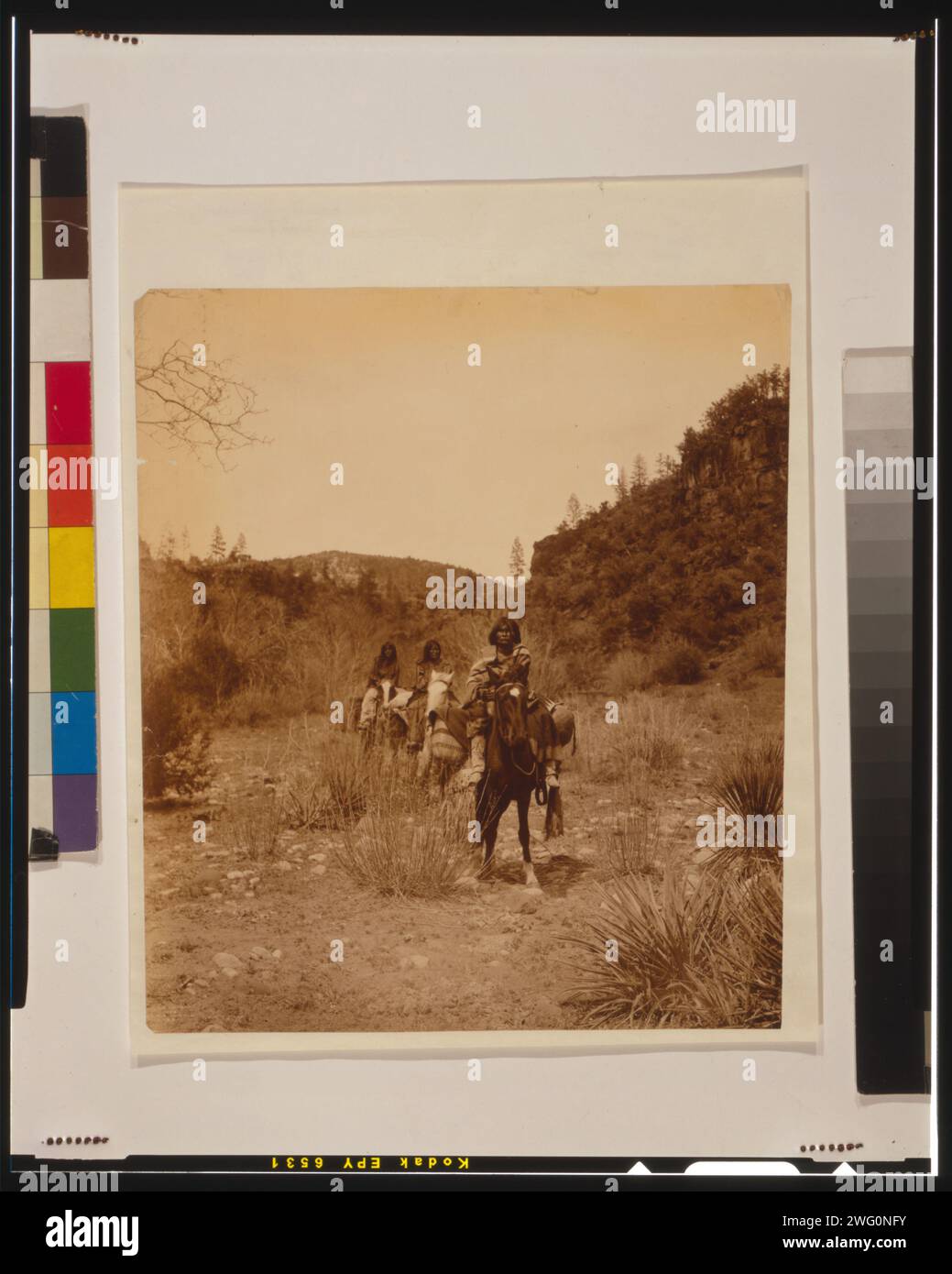 Apache land, c1903. Three Apache people riding pack horses make their ...