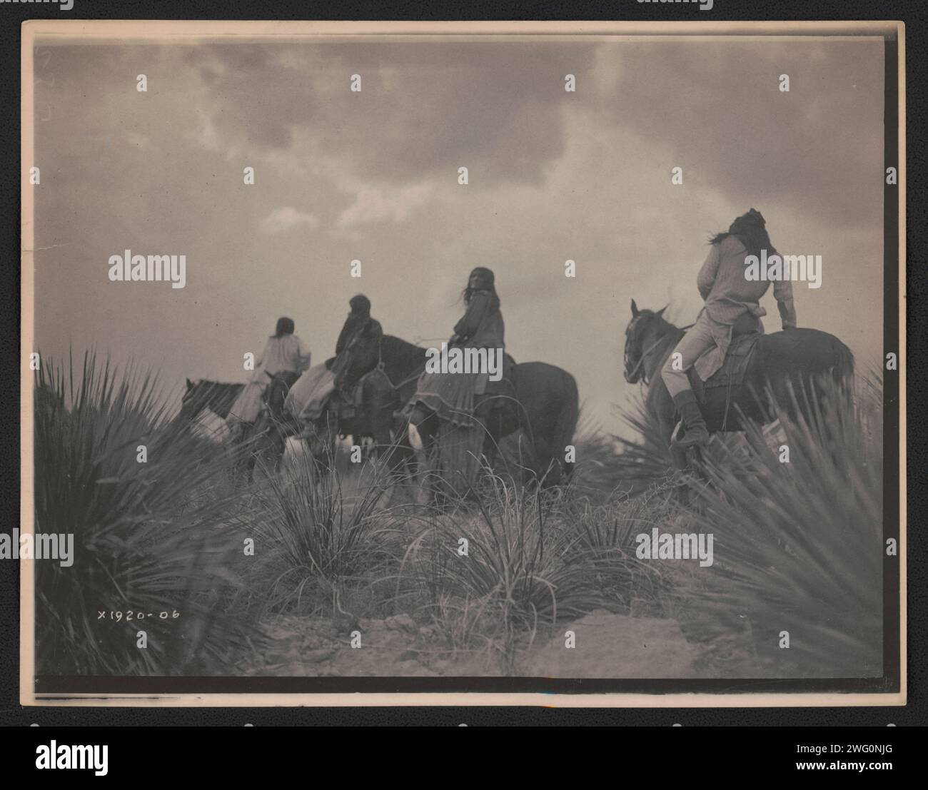 Before the storm, c1906. Four Apaches on horseback under storm clouds ...