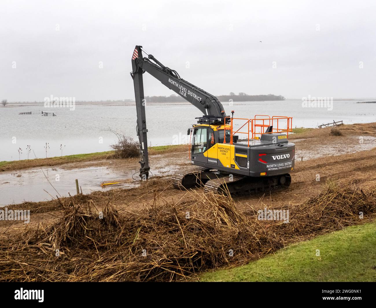 A machine clearing flood debris from a drainage ditch on the Nene ...