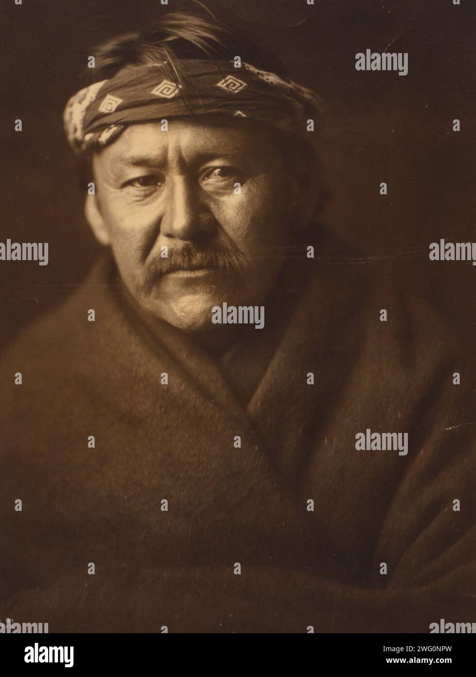 A Navajo man, head-and-shoulders portrait, wearing blanket and headband ...