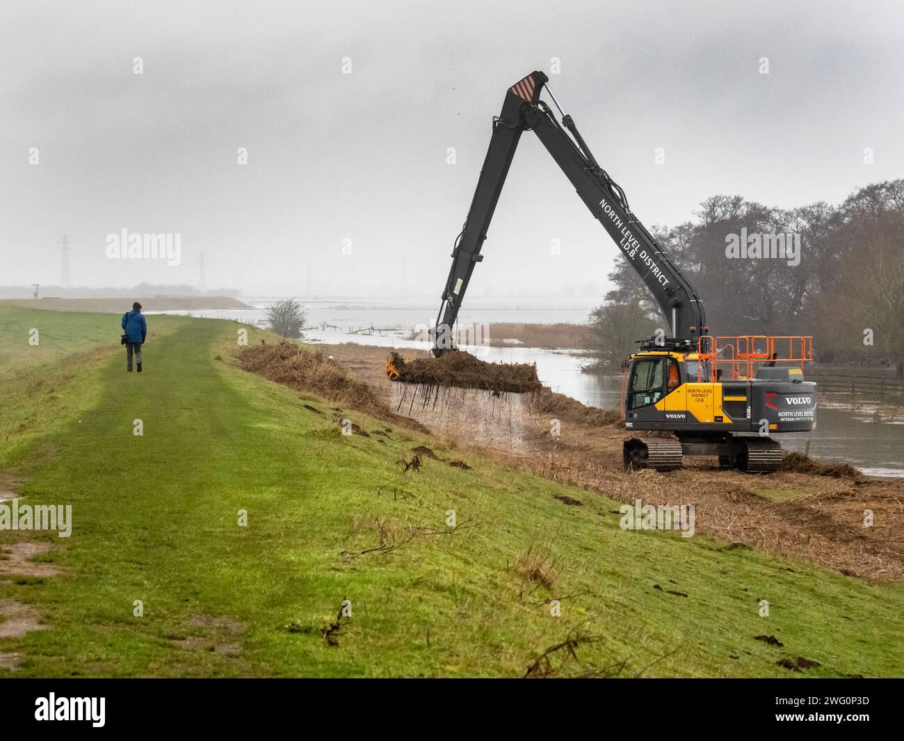 A machine clearing flood debris from a drainage ditch on the Nene ...