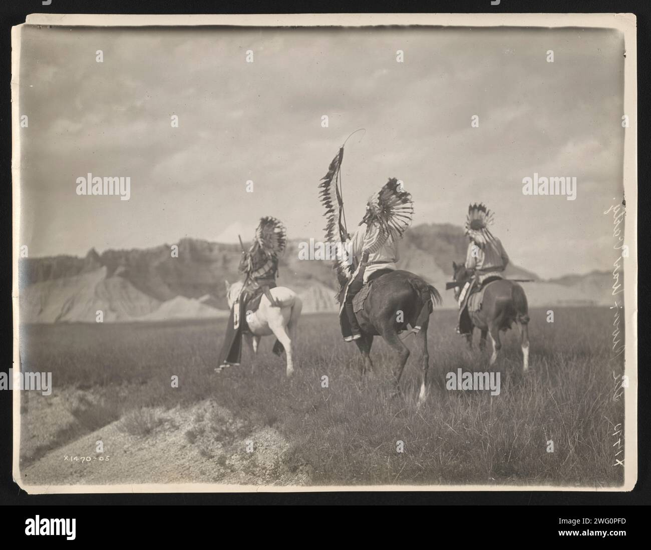 A Sioux war party, 1905. Photograph shows three warriors, wearing ...