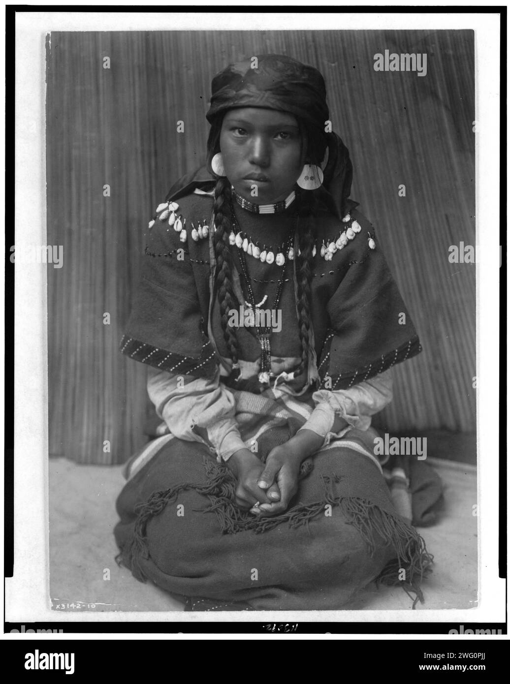 Touch Her Dress Kalispel C1910 Kalispel Girl Sitting On Her Knees Hands Folded In Lap Stock