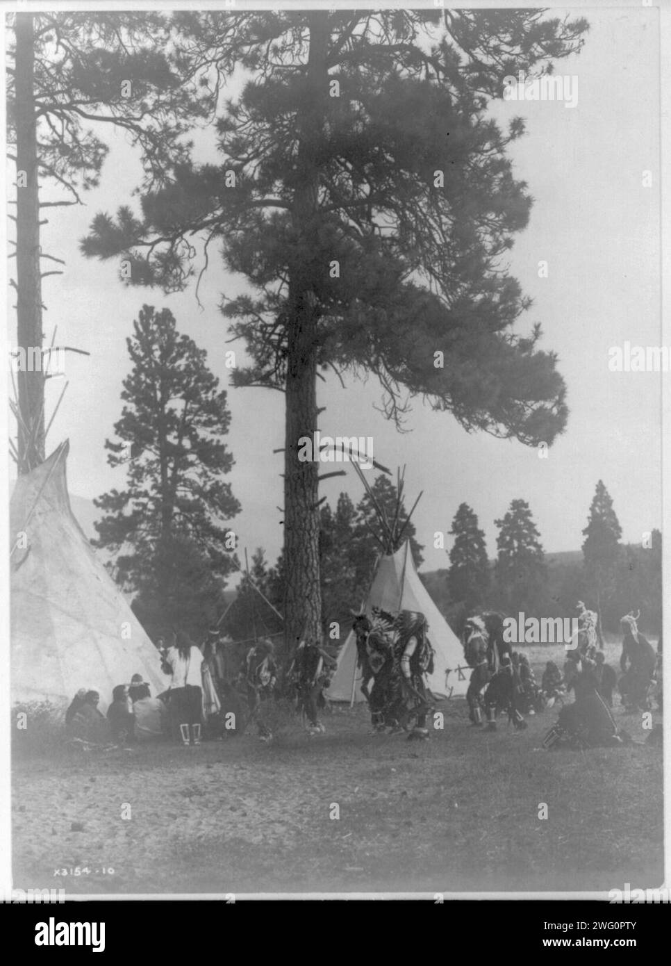 A Flathead dance, c1910. Flathead men dance in front of tepees under ...