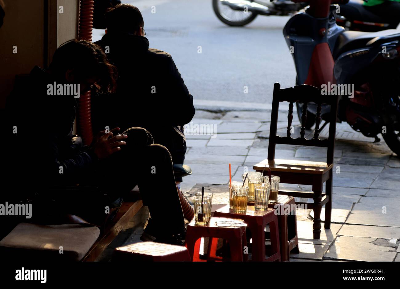 Drinking Tea along a street in the city of Hanoi Stock Photo - Alamy