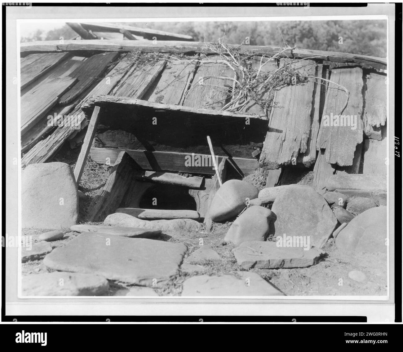 Entrance to a Yurok Sweat-house, c1923. Sheltered hole in mound of ...