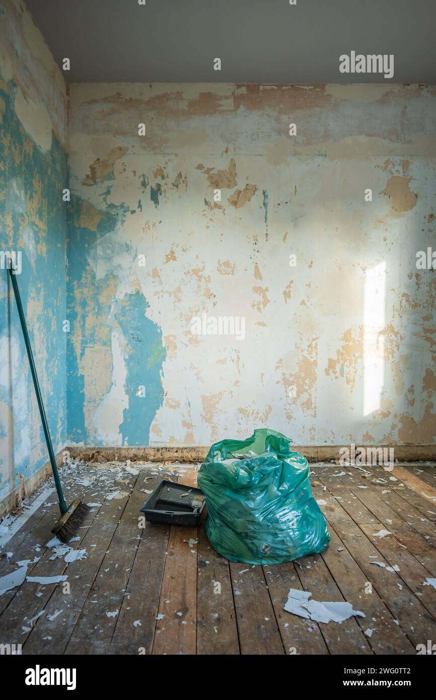 Rubbish bag full of stripped wallpaper pieces during room renovation in ...