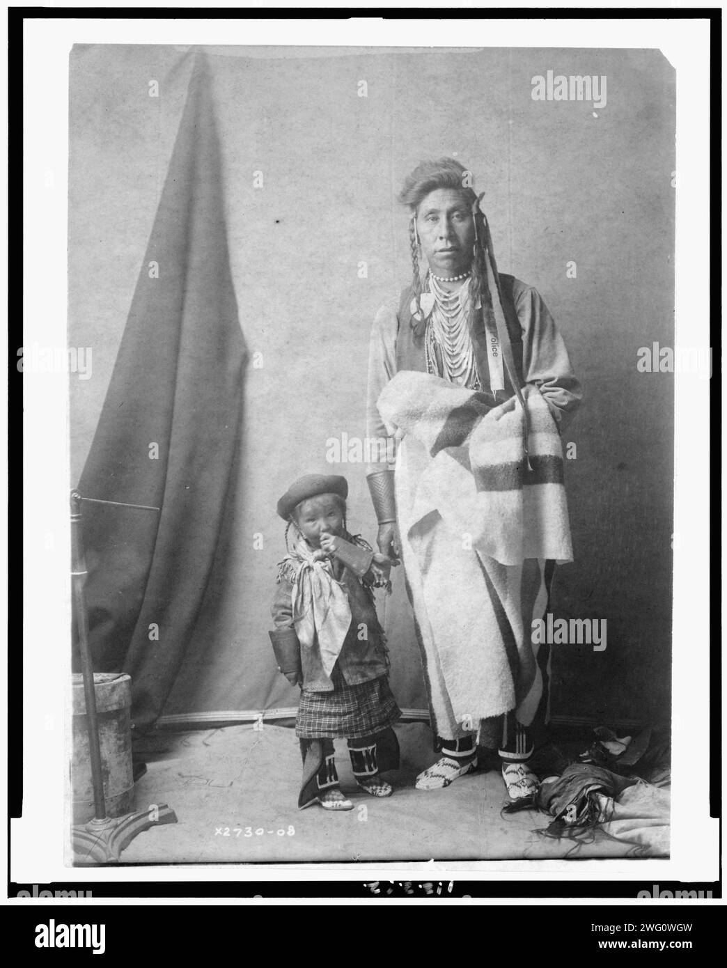Strong Enemy, c1908. Full-length portrait of Crow man and child Stock ...