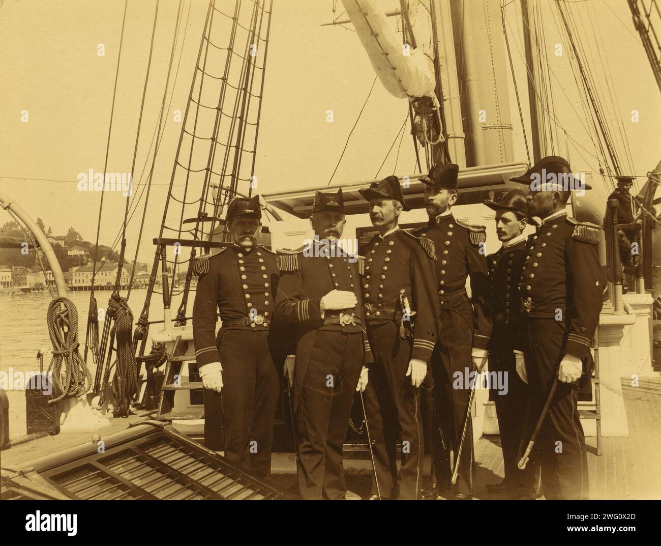 Six naval officers, full-length portrait, standing on deck of ship ...
