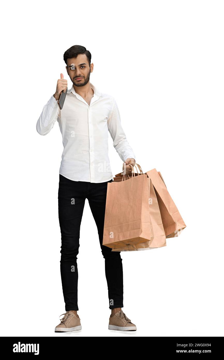 Man on a white background with shoppers show thumb up Stock Photo - Alamy