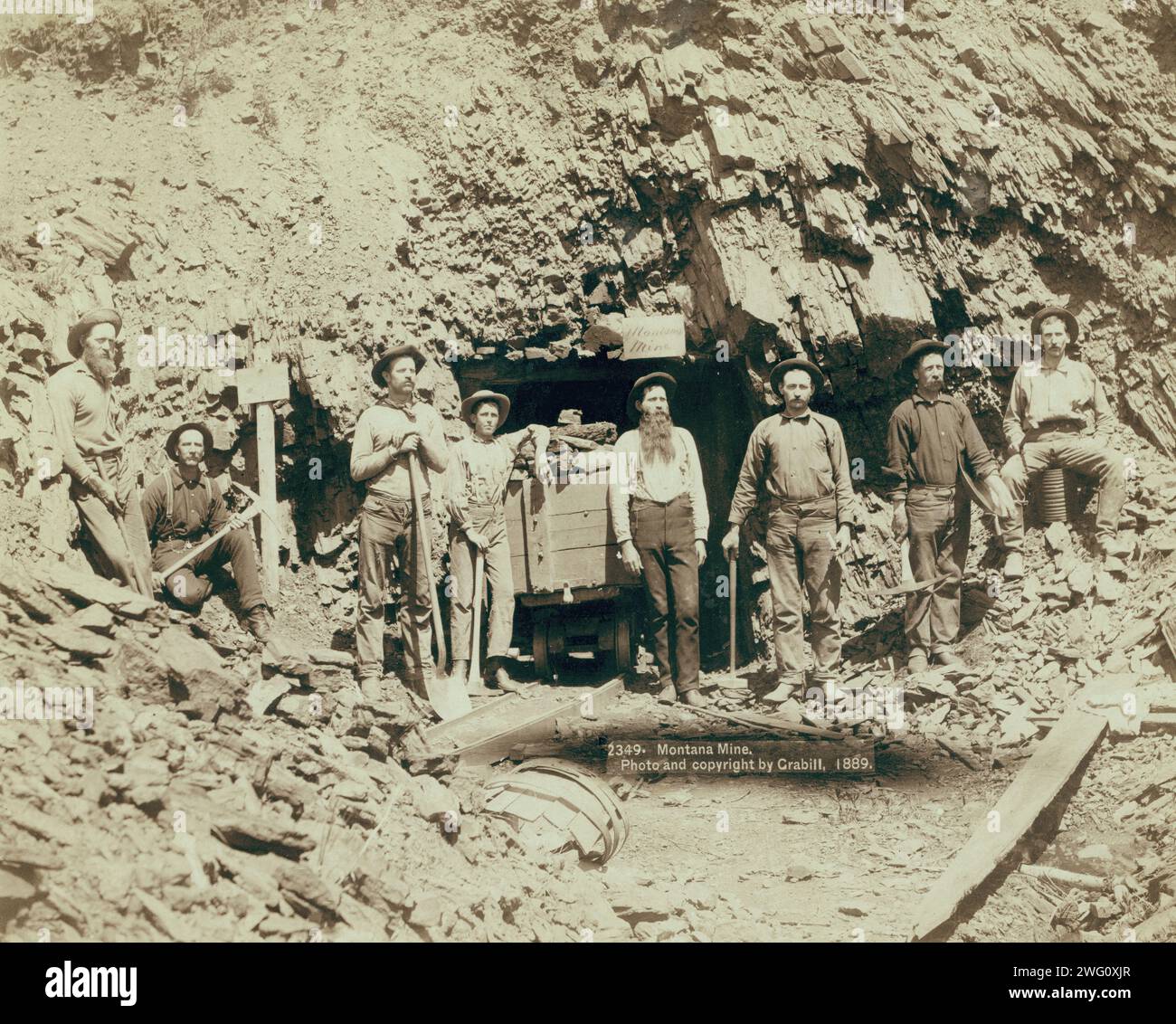 Montana Mine, 1889. Eight men, holding pick axes and shovels, standing ...