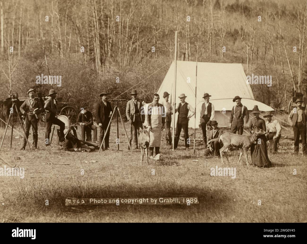 Engineers Corps camp and visitors, 1889. Row of fifteen people and two ...