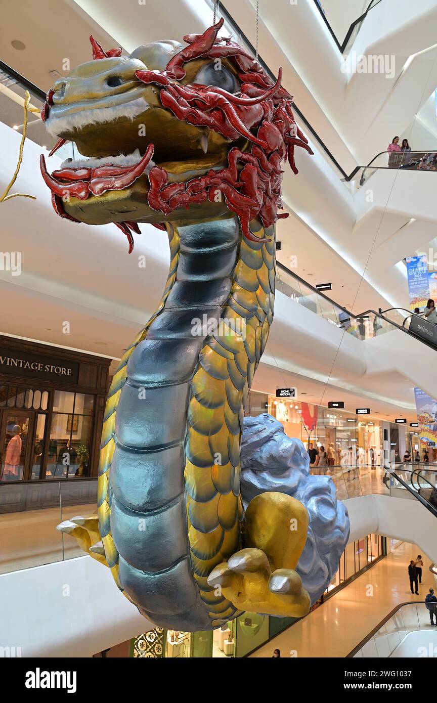 A gigantic dragon installation hovers over a Bangkok shopping mall as Thailand dresses up for ...