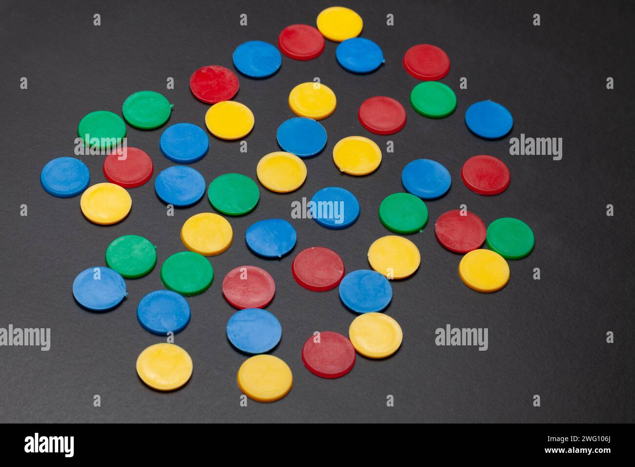 colorful round plastic tokens isolated on black background Stock Photo ...
