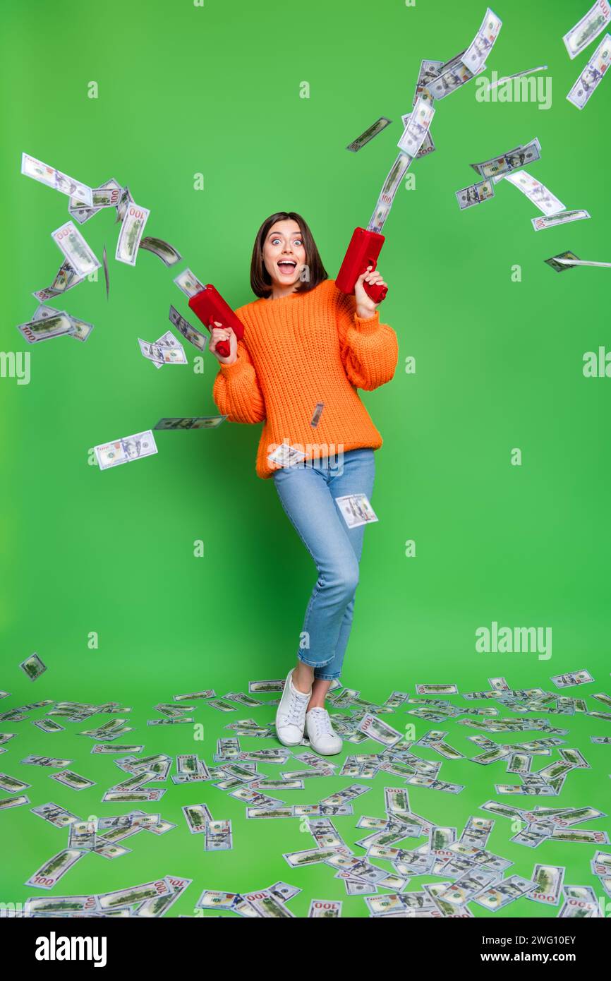 Full length vertical photo of astonished nice person hold money gun ...