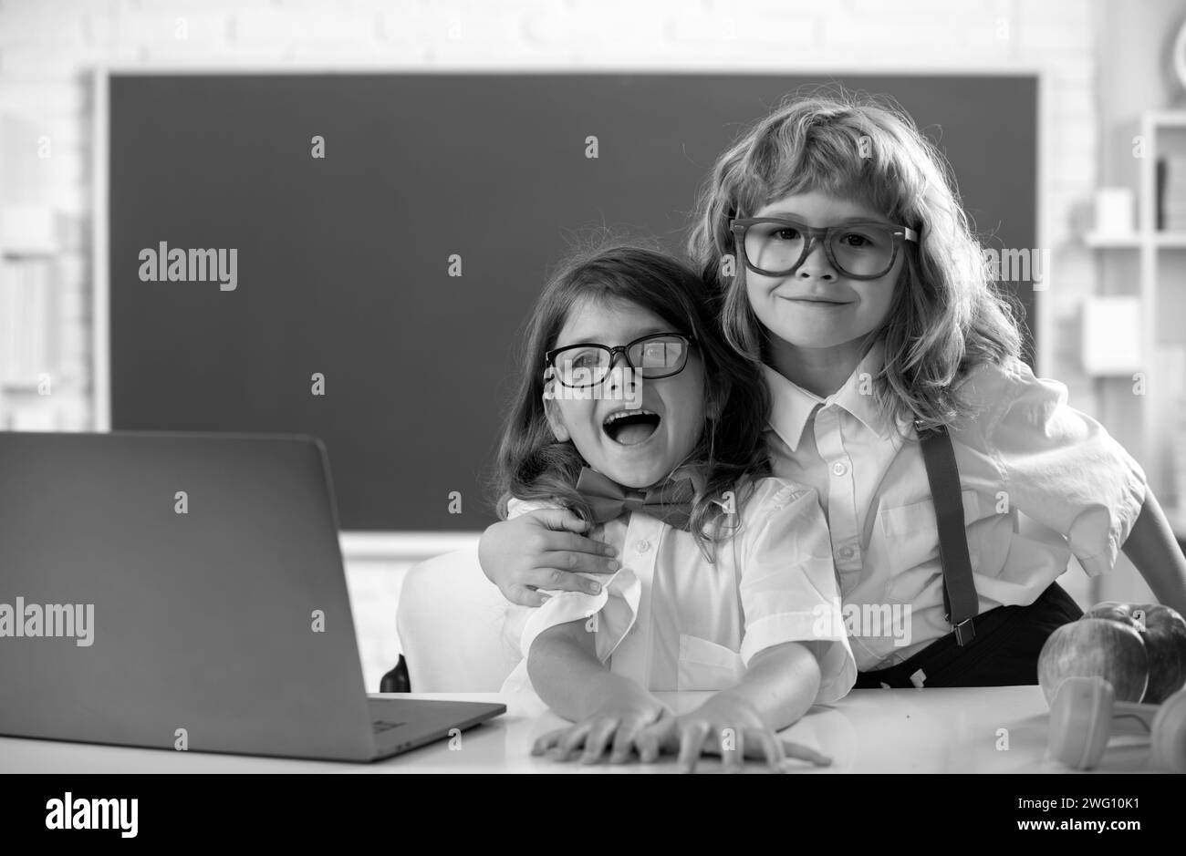 Back to school. Schoolgirl and schoolboy in classroom at school. Kids ...