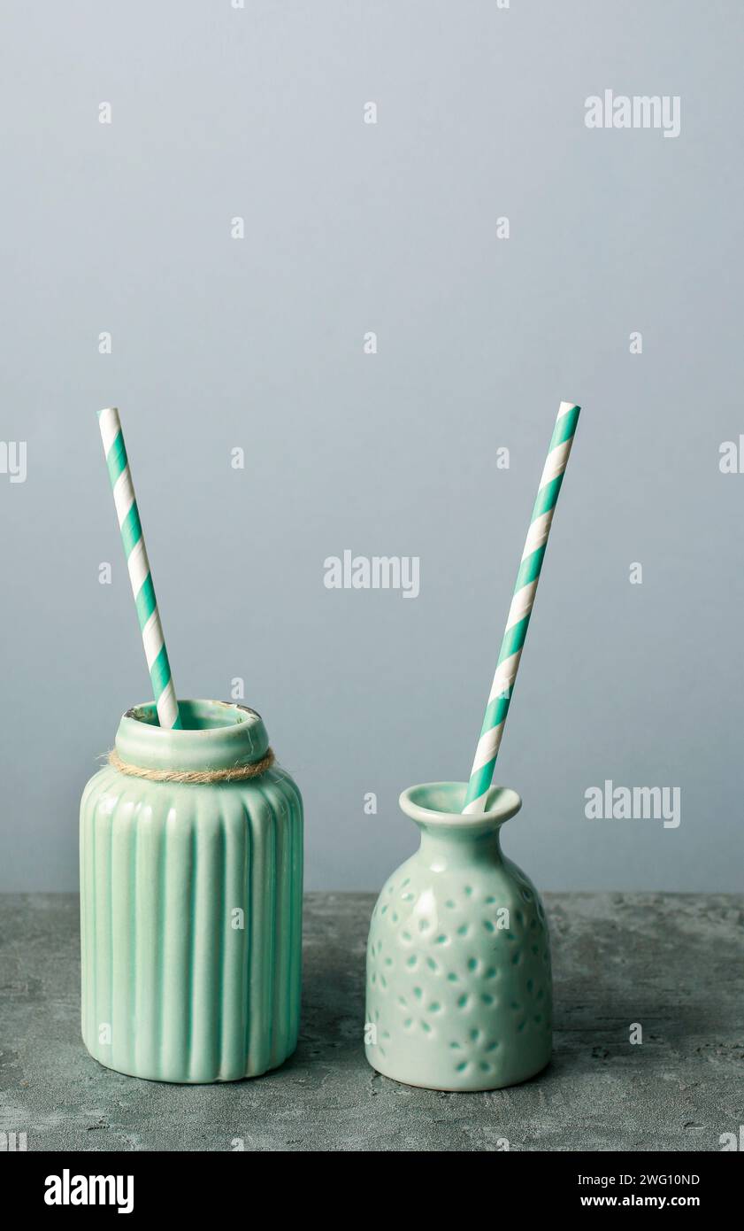 Ceramic jars and stripped straws. Party time Stock Photo - Alamy
