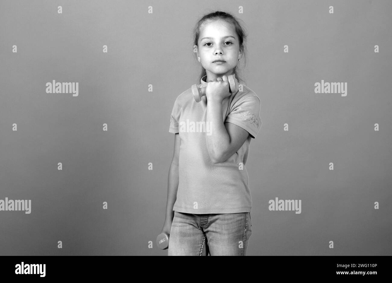 Sport child girl with strong biceps muscles. Kids exercising fitness ...