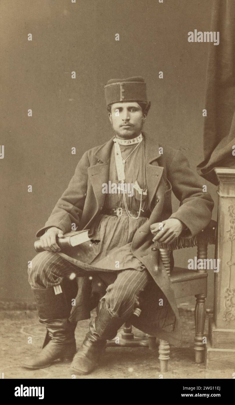 Full-length portrait of Persian man, seated, facing front, between 1870 ...